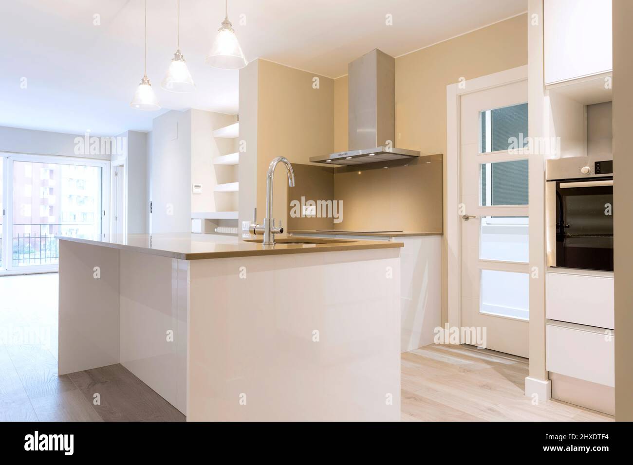 Open kitchen with island and terrace in the background Stock Photo - Alamy