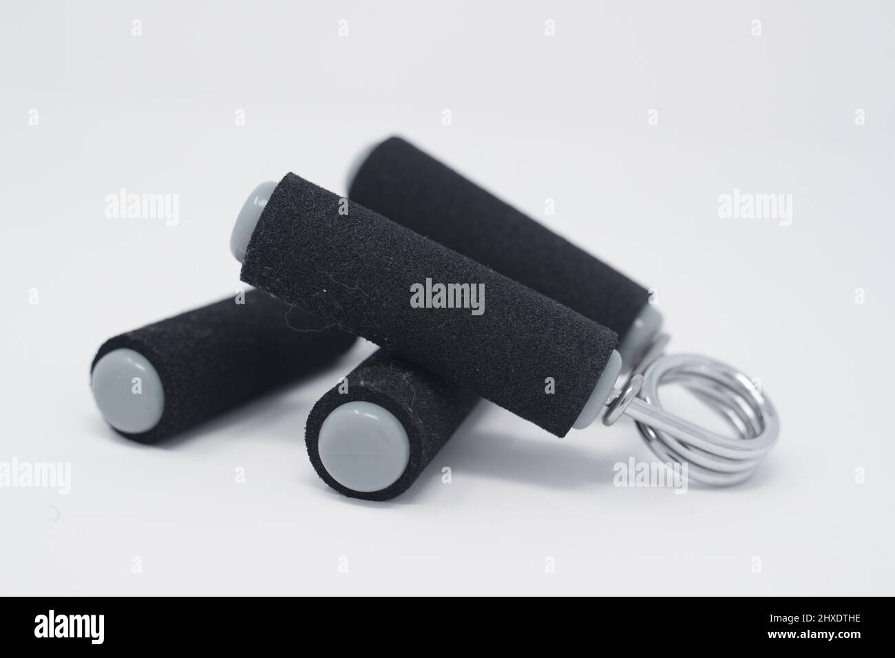 A pair of black hand grip exercisers on a white background Stock Photo ...