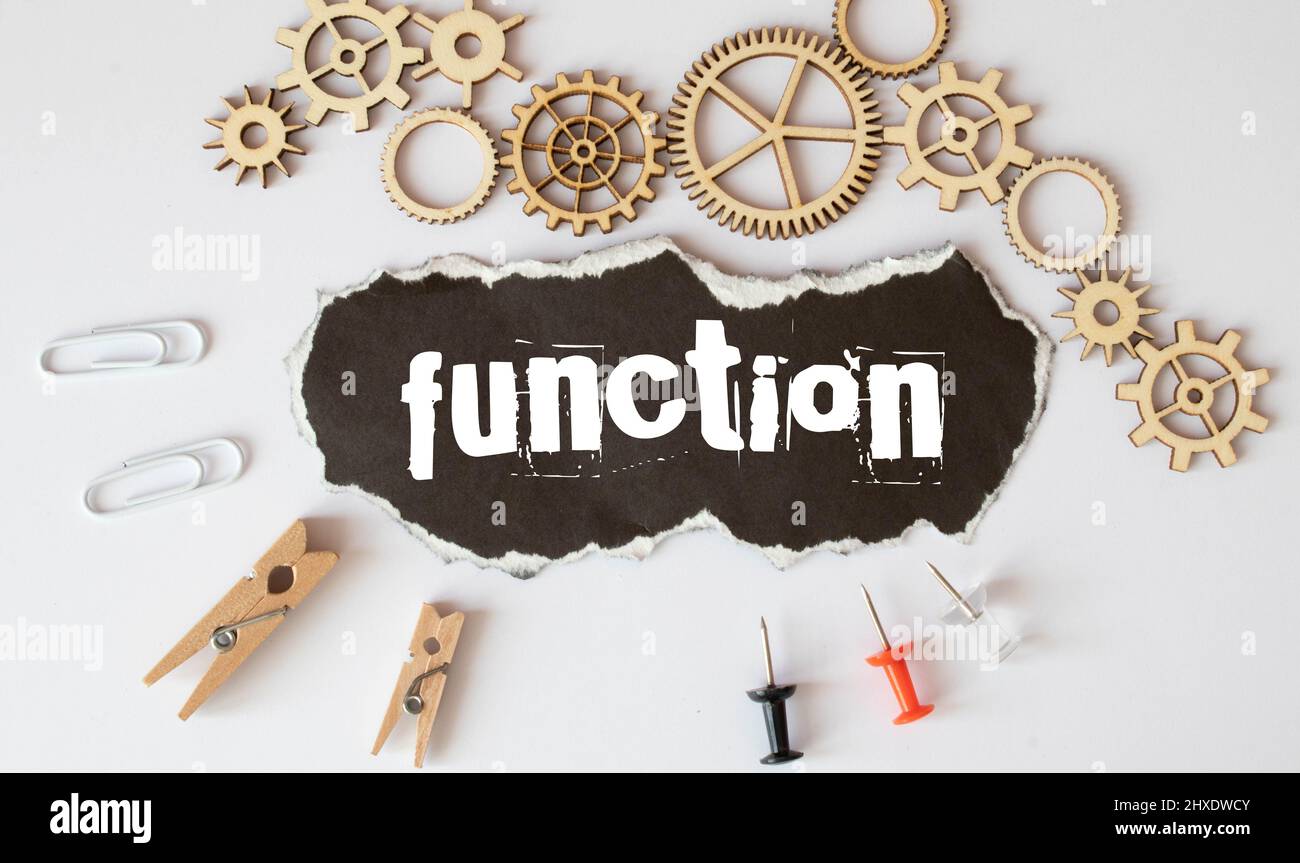 text on gray word function in small wooden letters with black font on a ...