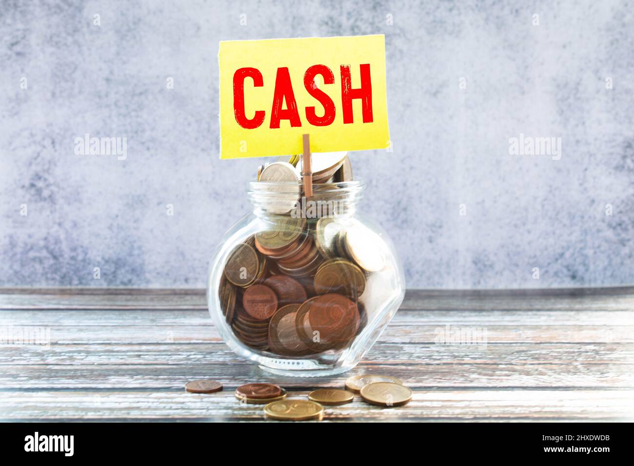 The word CASH is written on wooden cubes near a calculator on a ...