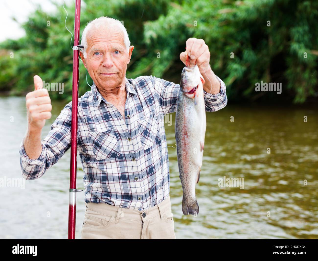 Happy aged man holding fishing hi-res stock photography and images - Alamy