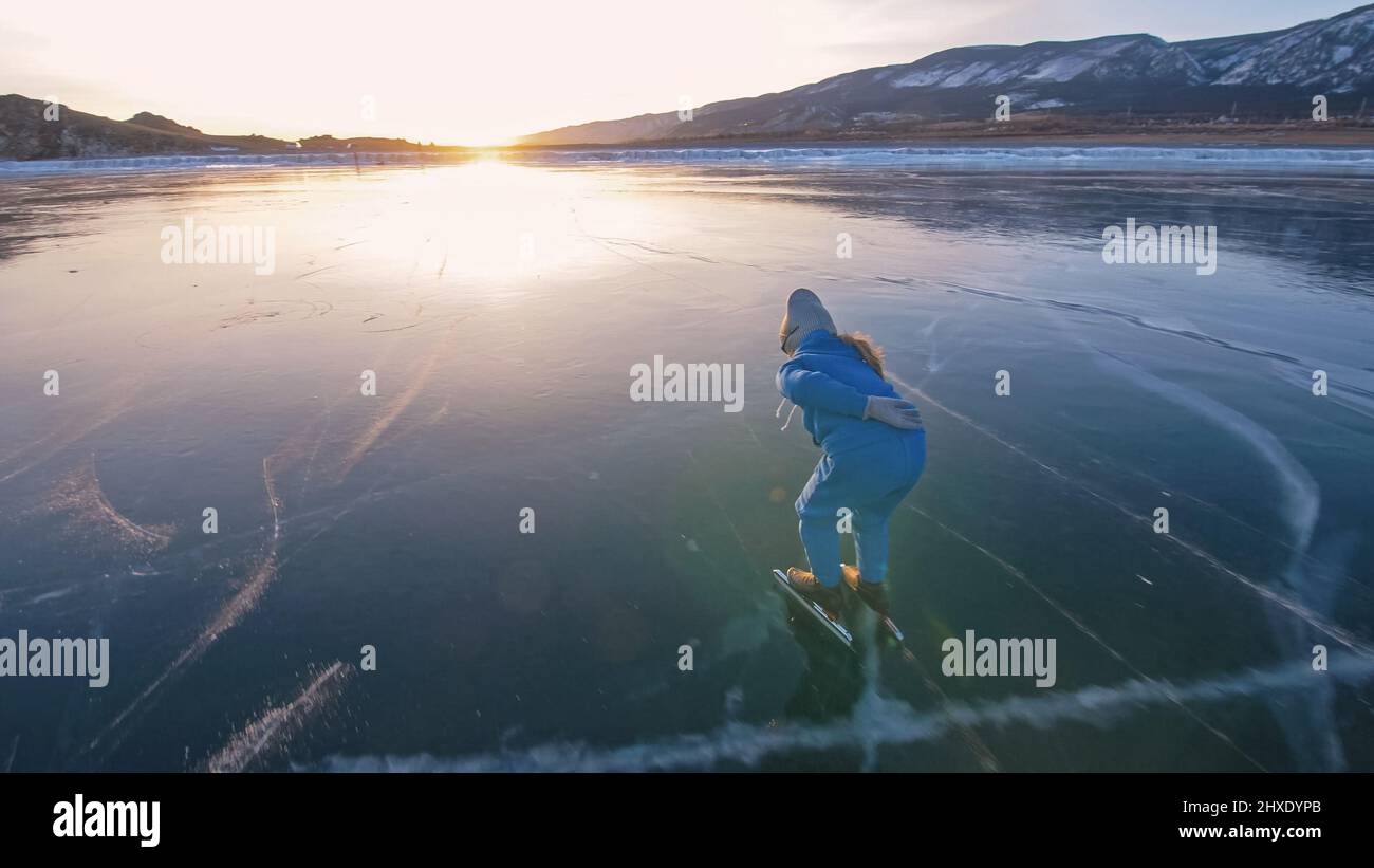 The child train on ice professional speed skating. The girl skates in ...