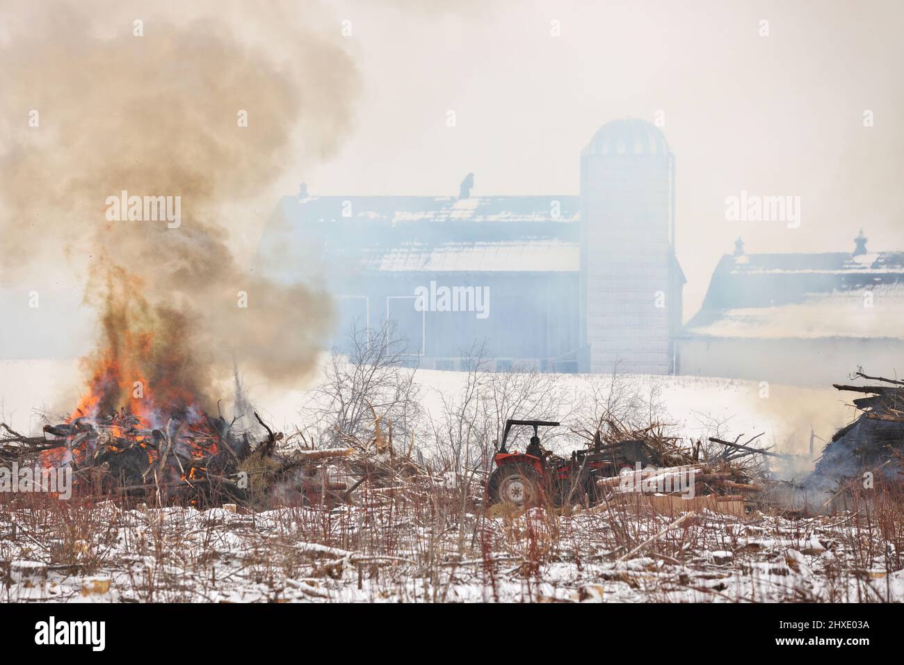 Tractor Moves Brush During a Controlled Burn on a Farm Property to ...