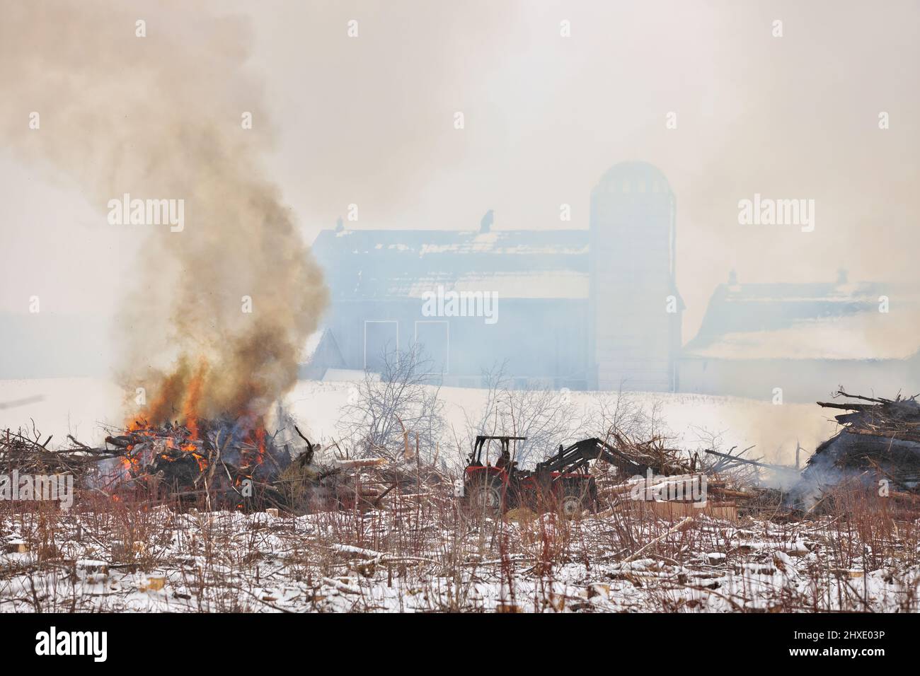 Tractor Moves Brush During a Controlled Burn on a Farm Property to ...