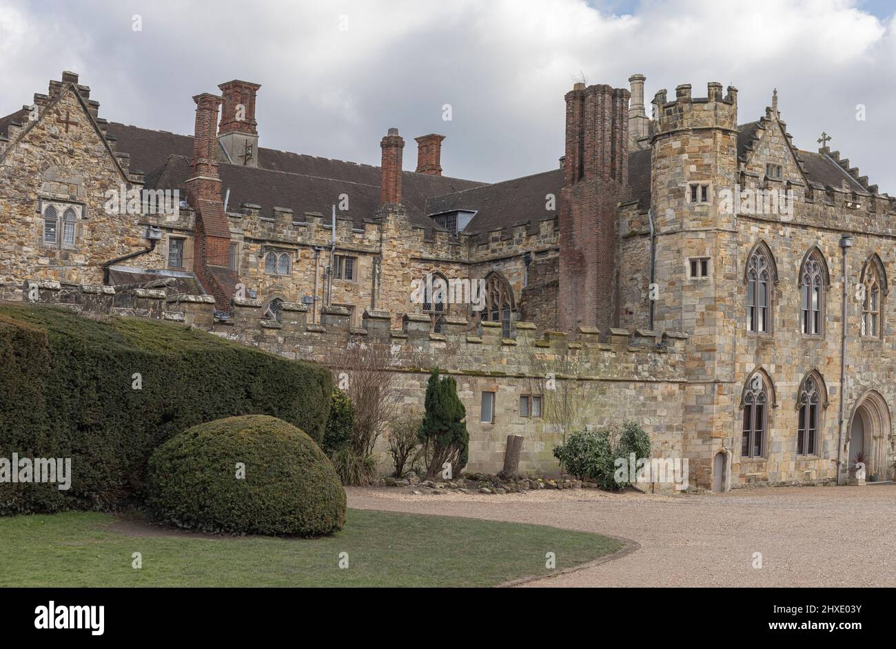 view of the front of a retro gothic castle with tall chimneys and ...