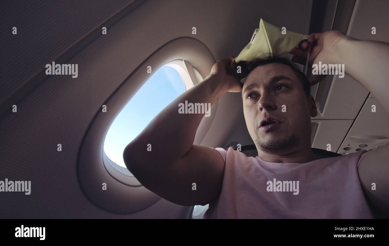 Man travel caucasian at plane with wearing protective medical mask ...