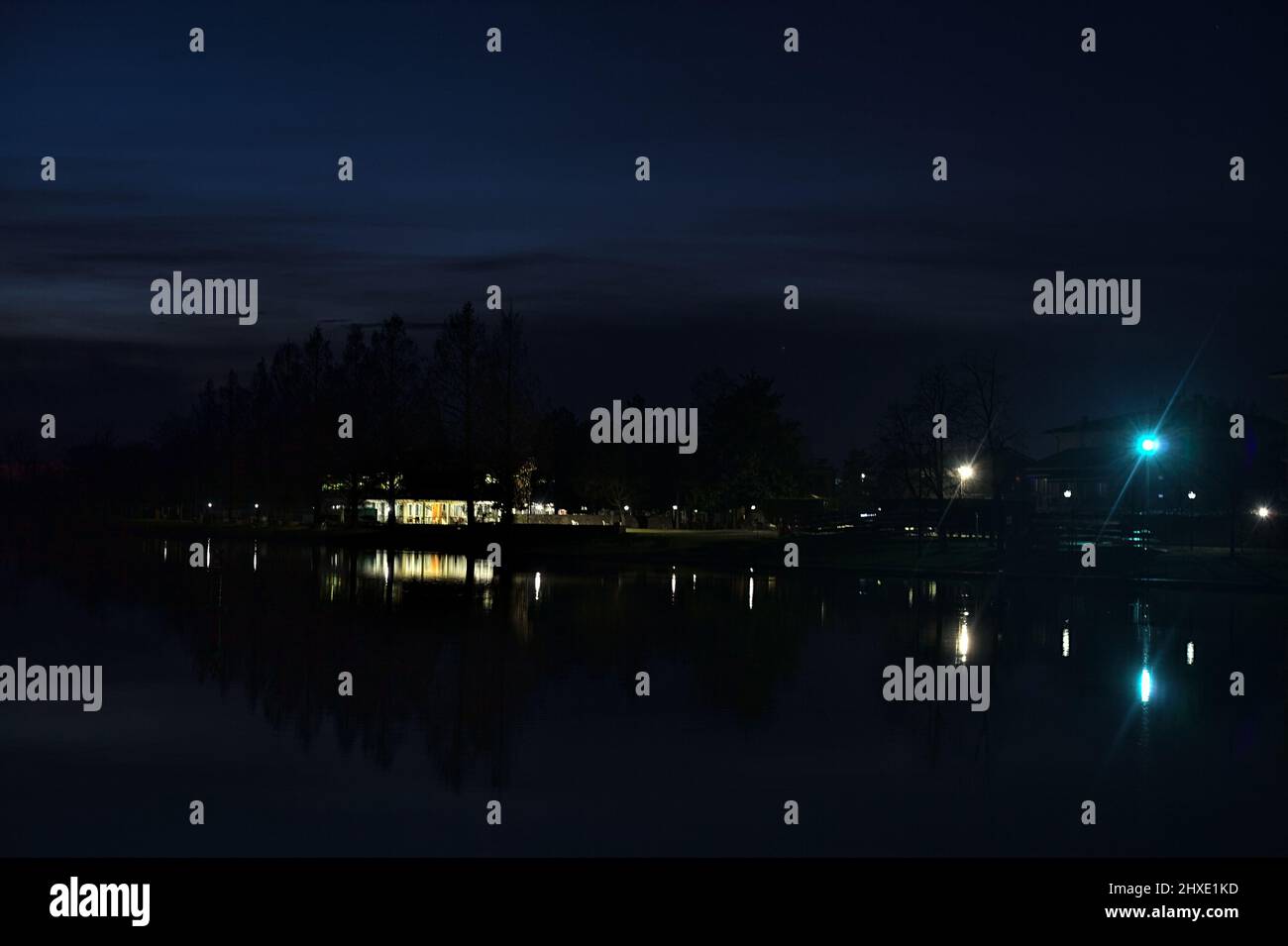 Lights from a building and street lamps in the distance casted on a ...