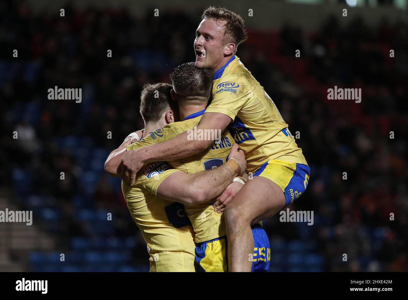 Jez Litten #14 of Hull KR celebrates with try scorer Mikey Lewis #20 of ...