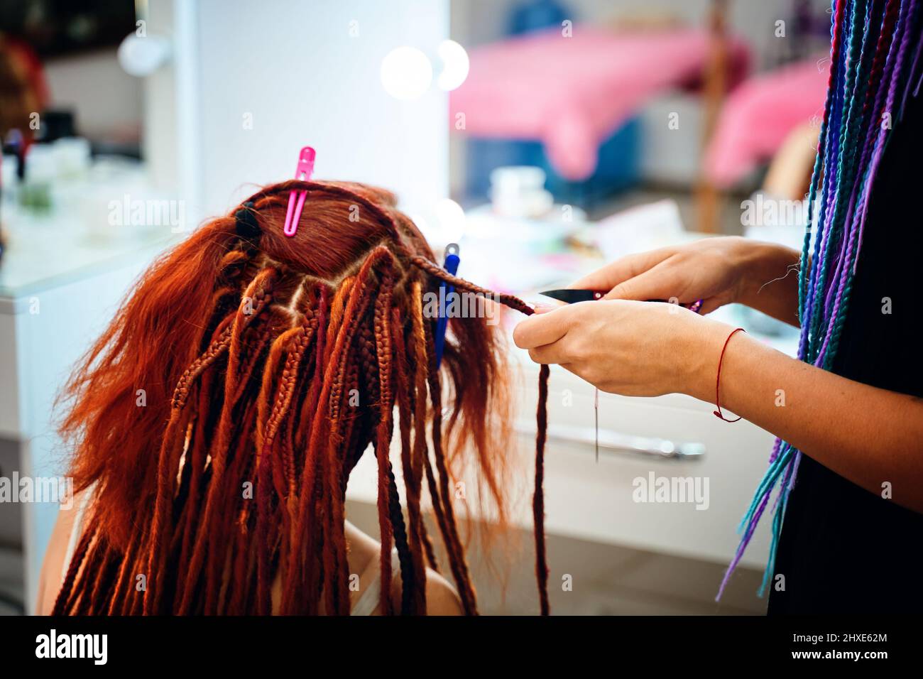 Braiding process african plaits with colored kanekalon Stock Photo - Alamy