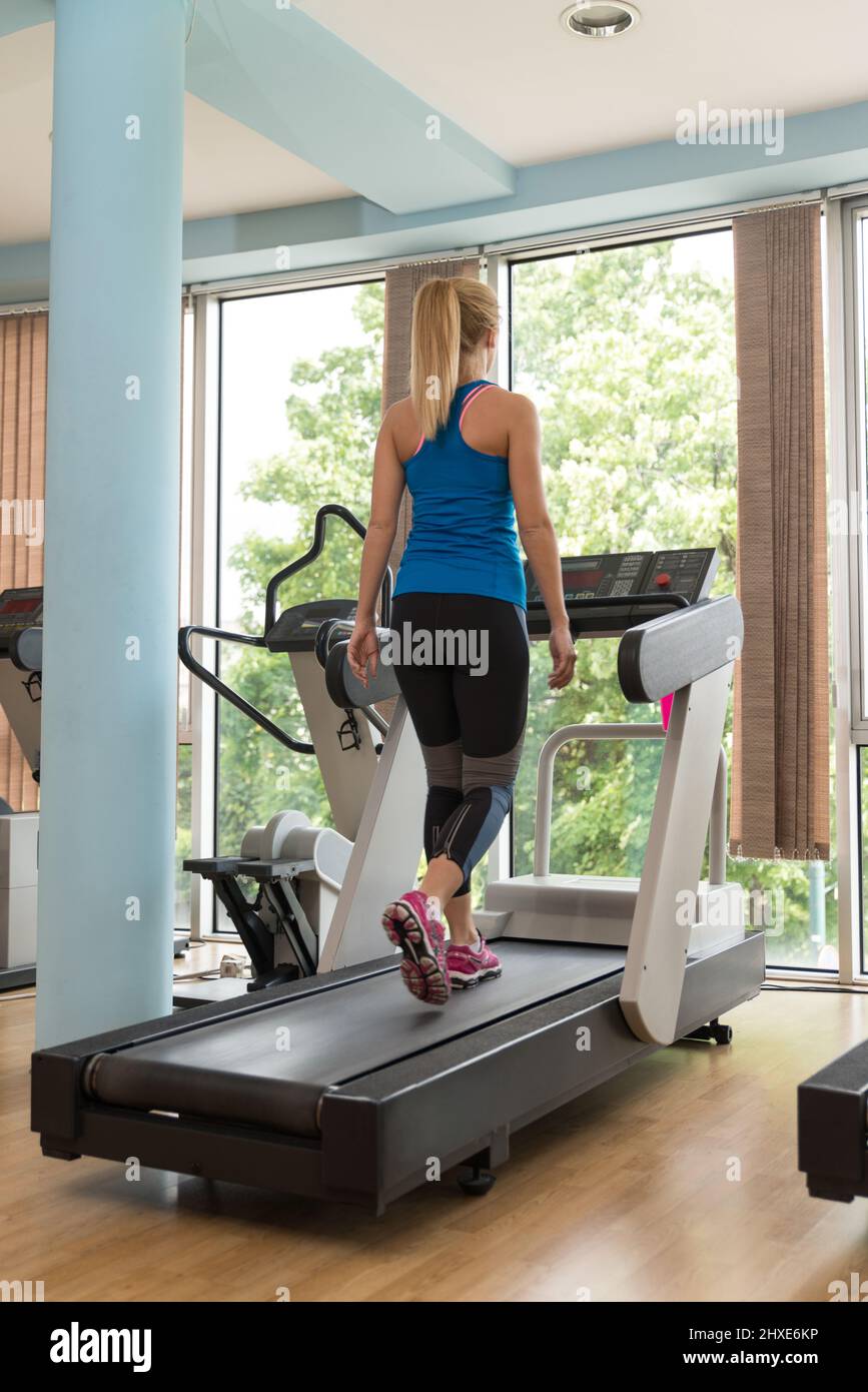Attractive Young Sports Woman Is Working Out in Gym - Doing Cardio ...