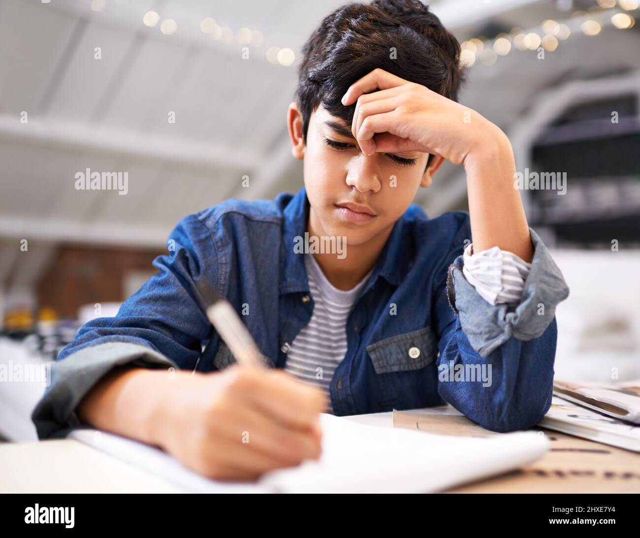 Focused on his schooling. Image of a young boy doing his homework Stock ...