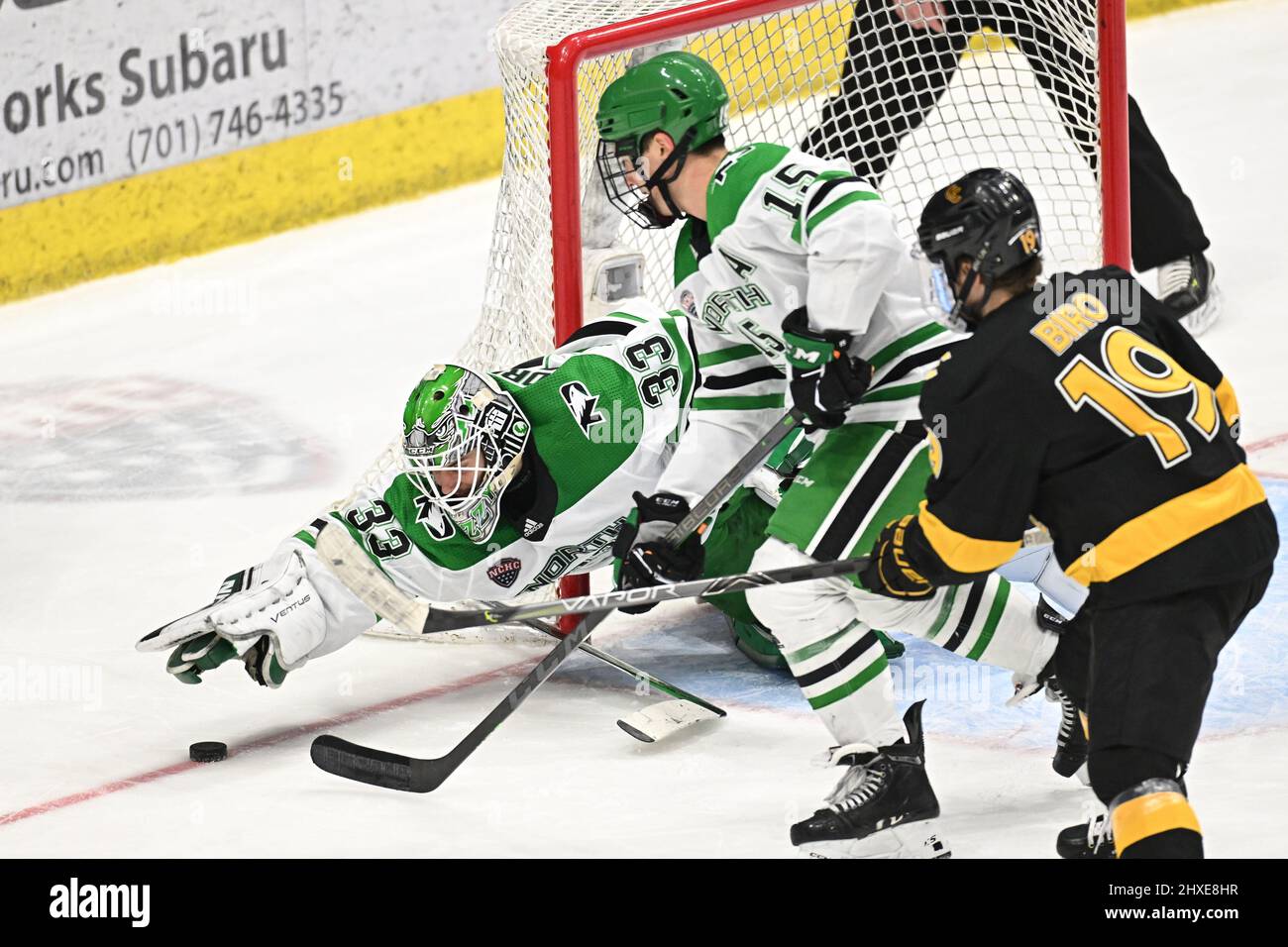 North Dakota Fighting Hawks goaltender Zach Driscoll (33) dives to cover a puck during game one ...