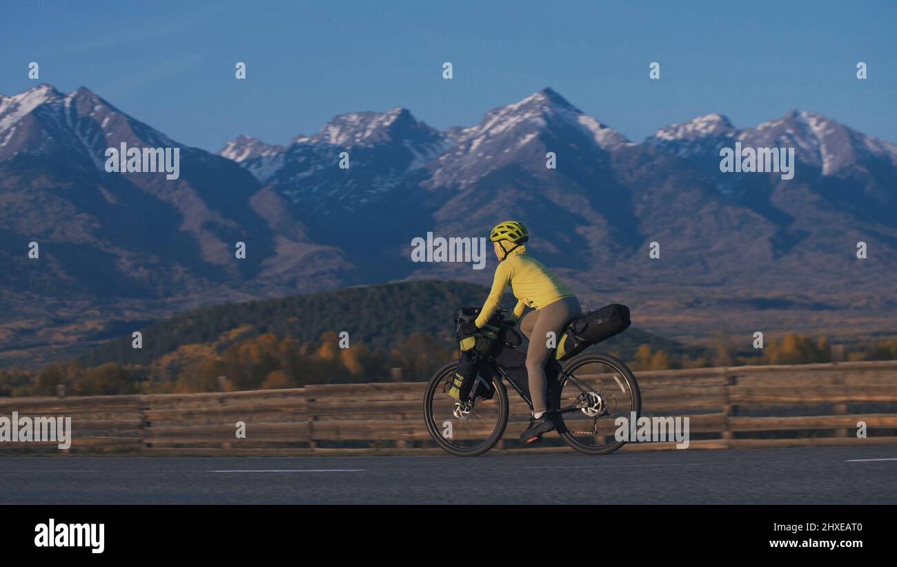 The woman travel on mixed terrain cycle touring with bikepacking. The ...