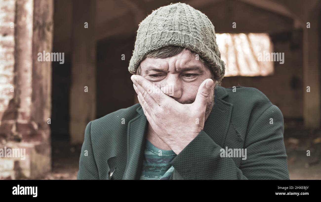 Homeless man face in hands hi-res stock photography and images - Alamy