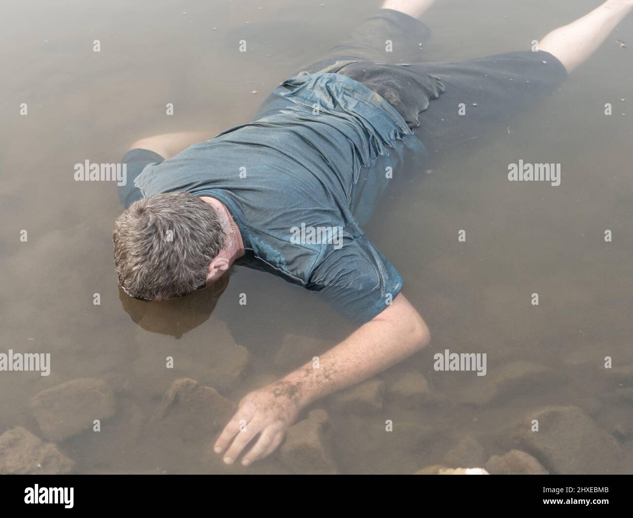 a corpse in the water, the body of a dead man was found by the lake near the pond, a drowned man ...