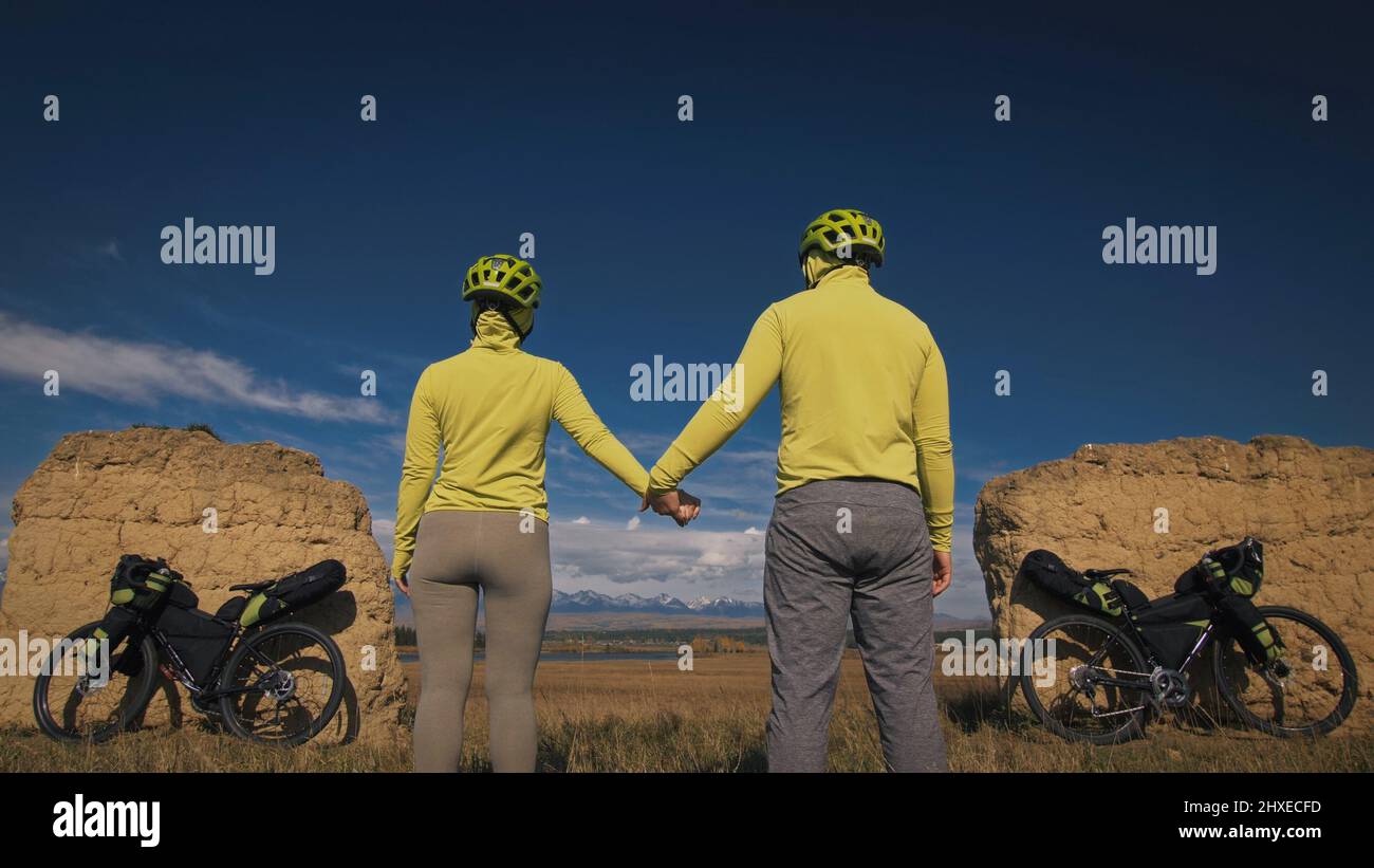 The man and woman travel on mixed terrain cycle bike touring with ...
