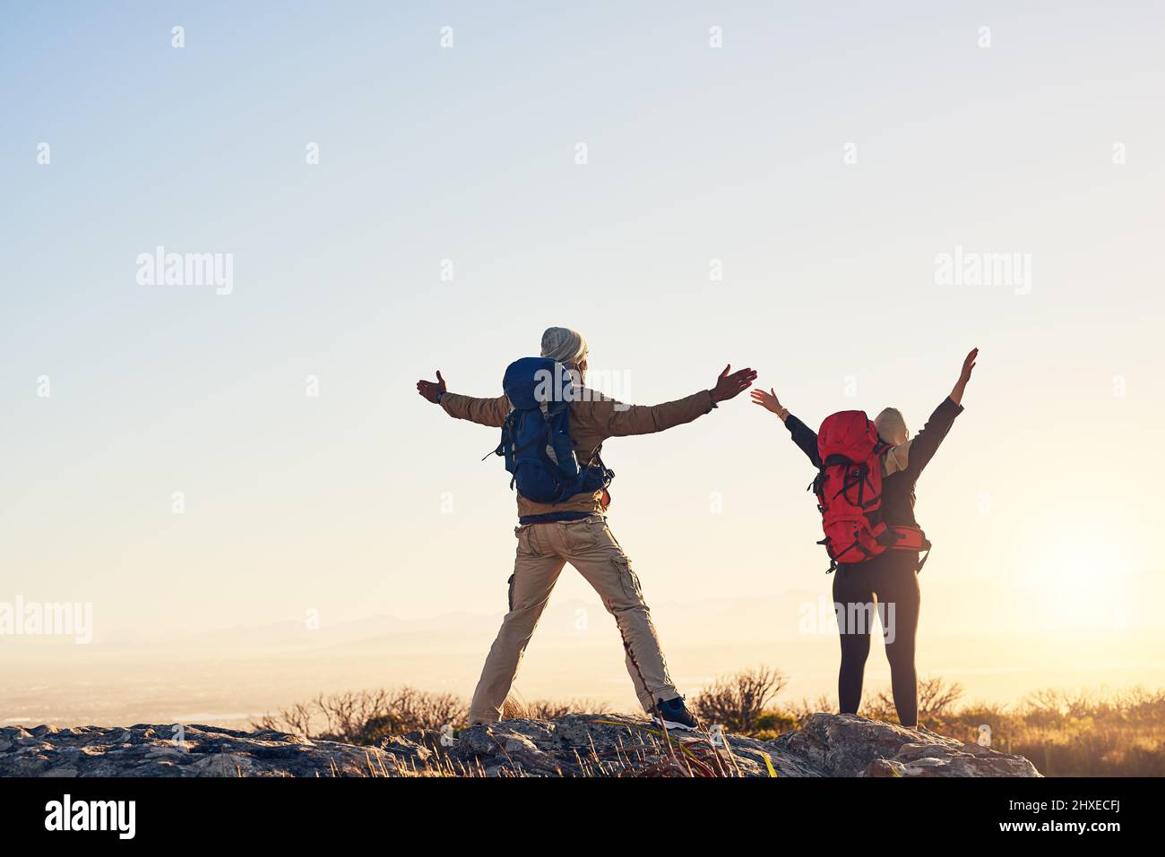 Freedom at its very best. Shot of two hikers on top of a mountain with ...