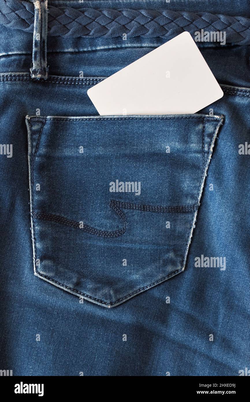 The upper part of old worn blue jeans with pockets and a white tag for ...