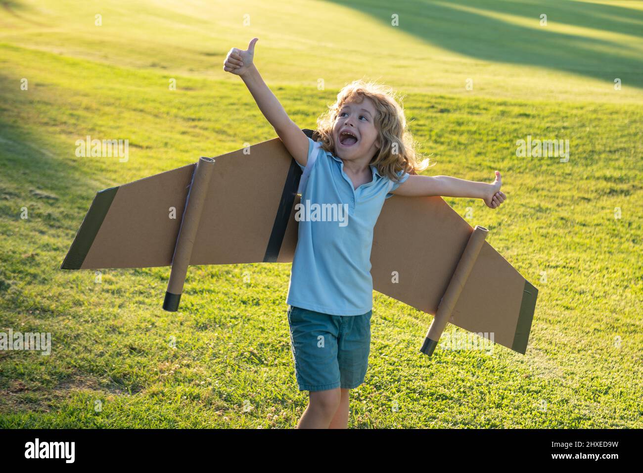 Kid superhero with jetpack. Child pilot play on summer day. Excited ...