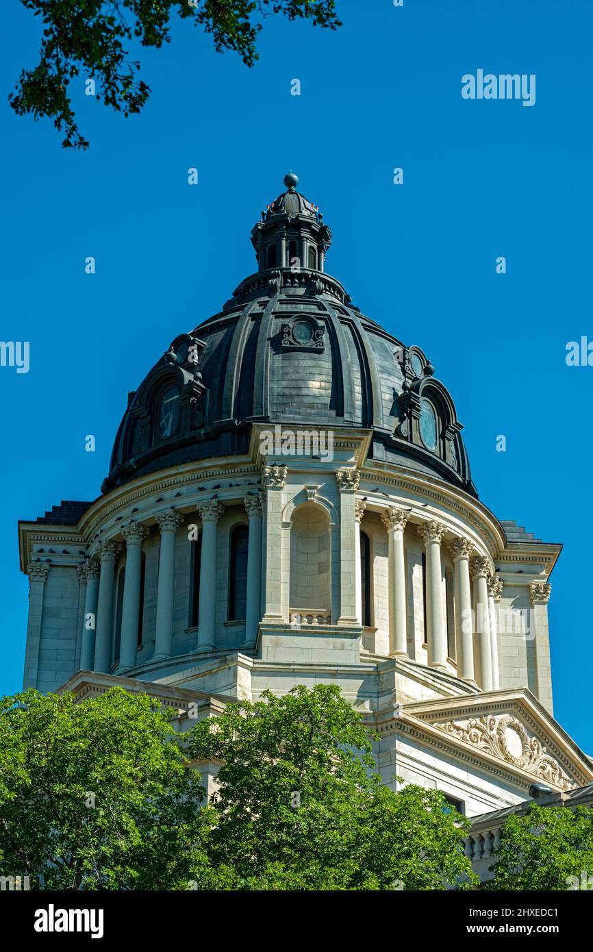 The dome of the State Capitol framed by trees in Pierre, South Dakota ...