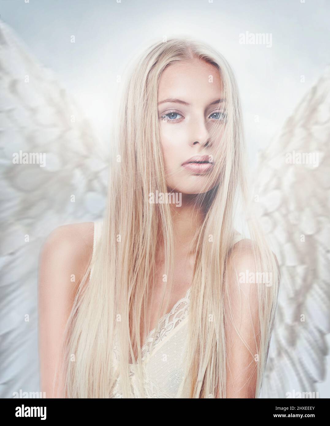 Angels are perfect beings. Shot of a beautiful angel looking at at the ...