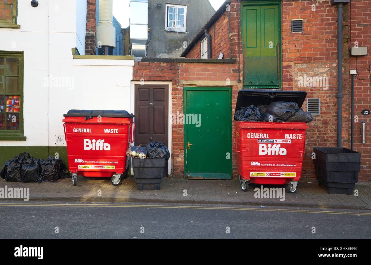 Commercial wheelie bins on a sidewalk in the UK Stock Photo - Alamy