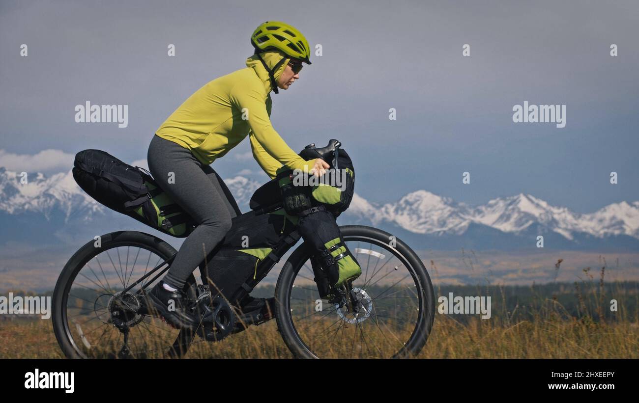 The woman travel on mixed terrain cycle touring with bikepacking. The ...