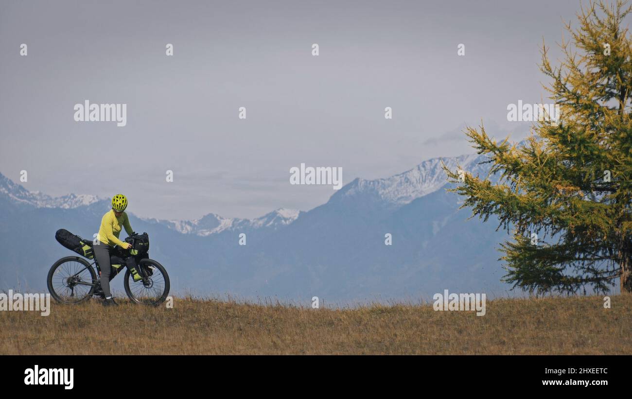 The woman travel on mixed terrain cycle touring with bikepacking. The ...