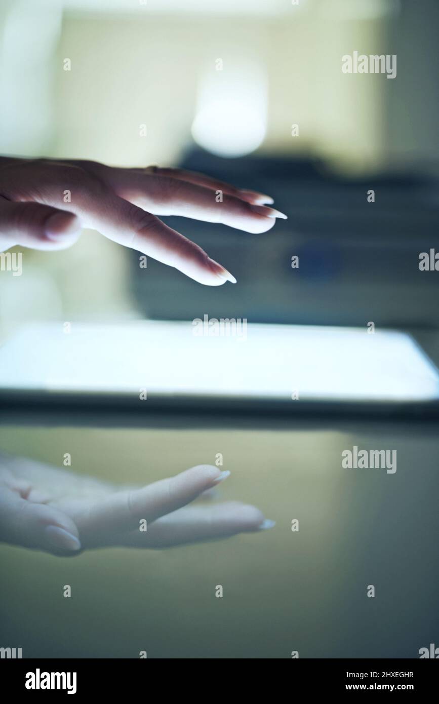 Data at her touch. Closeup of a young woman holding a touch sensitive ...