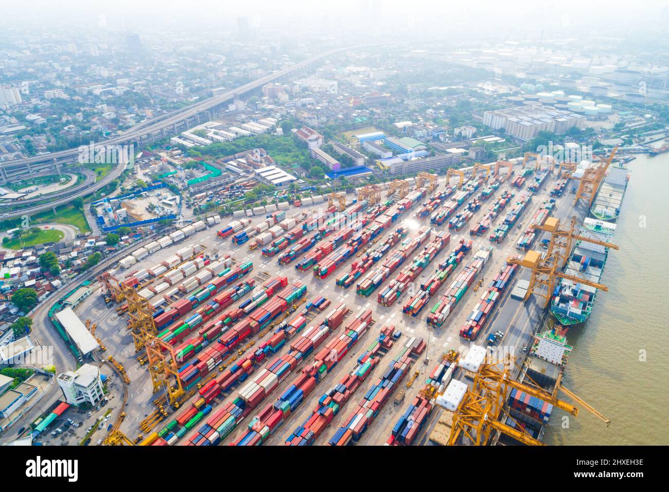 Container cargo ship with working crane bridge in shipping import ...