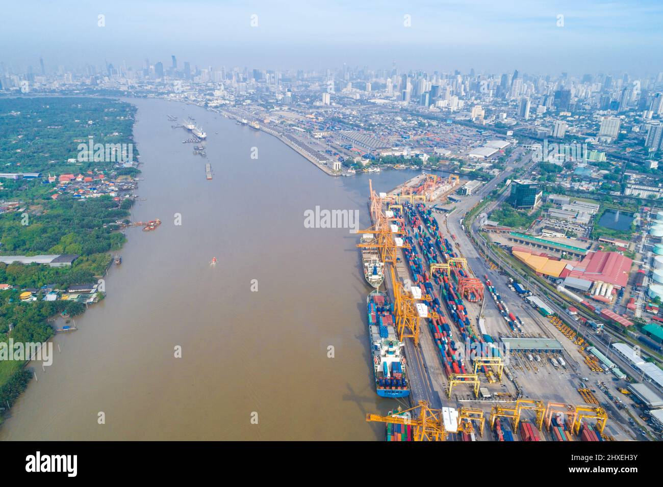 Container cargo ship with working crane bridge in shipping import ...