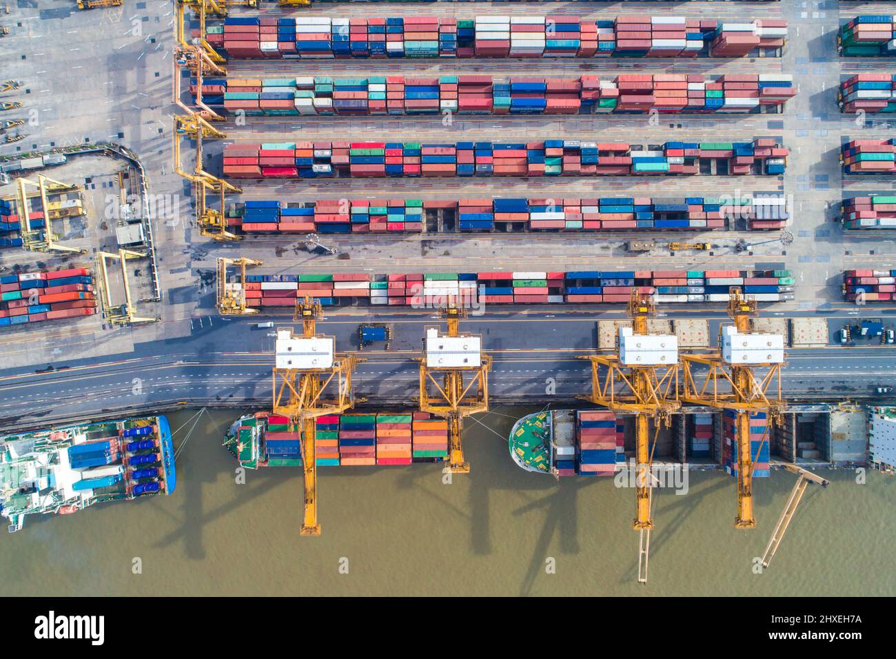 Container cargo ship with working crane bridge in shipping import ...