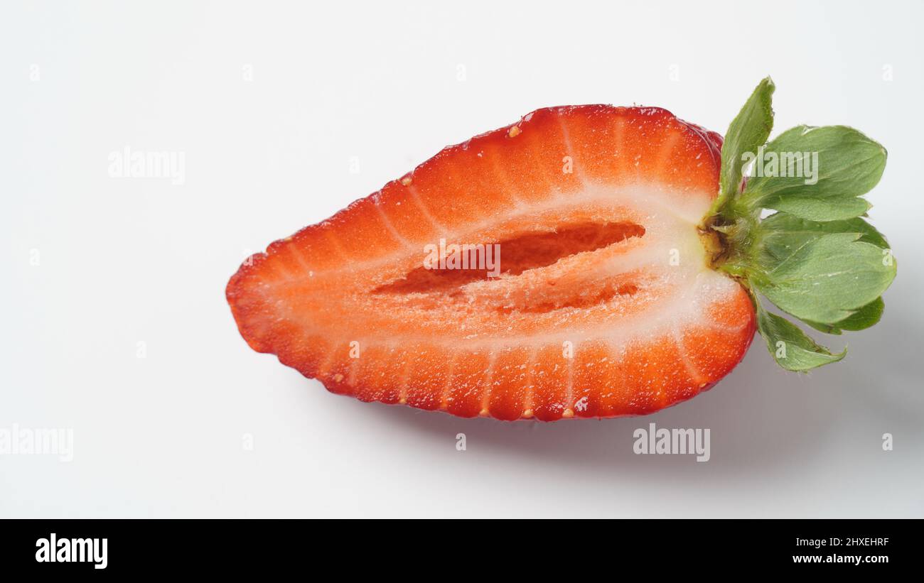 Sweet fresh strawberry half cut on white background Stock Photo - Alamy