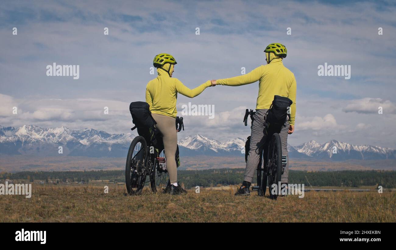 The man and woman travel on mixed terrain cycle touring with ...