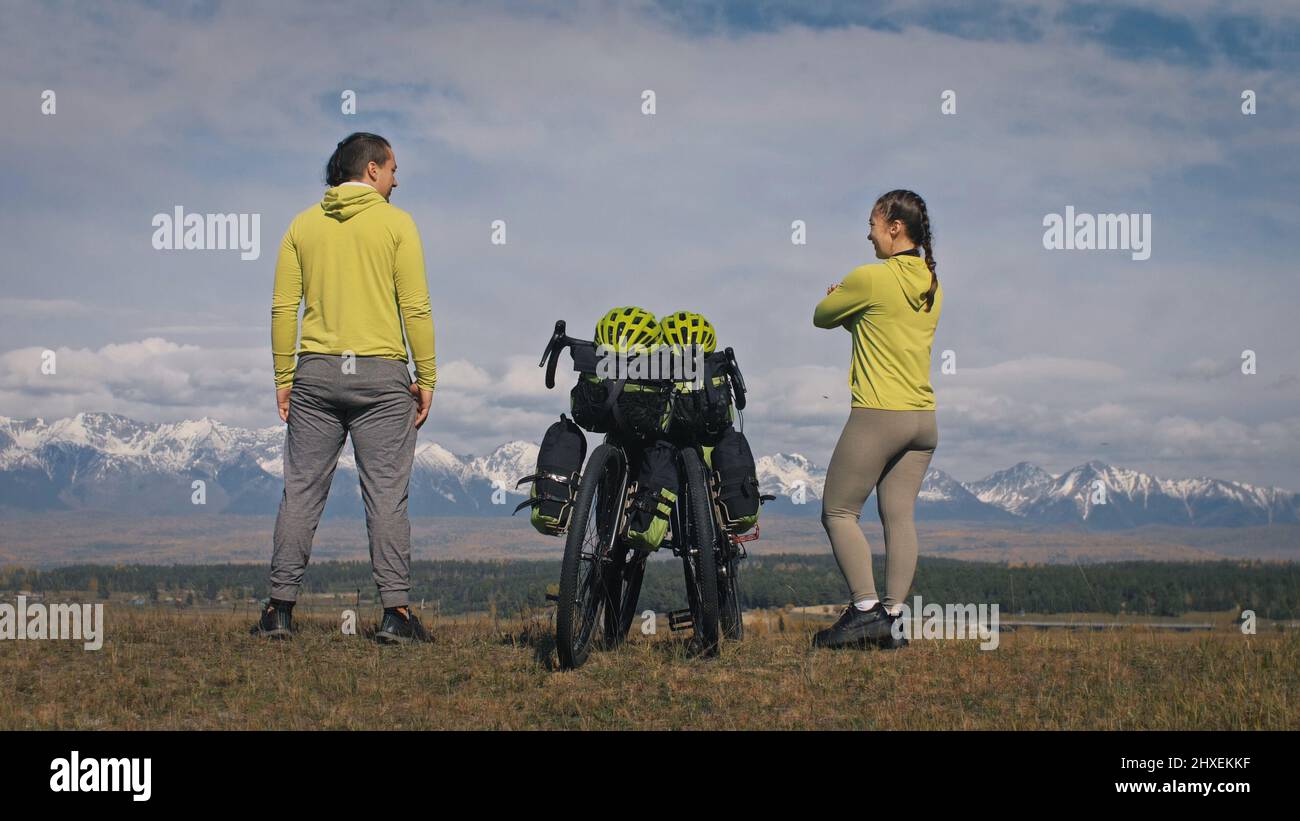 The man and woman travel on mixed terrain cycle touring with ...