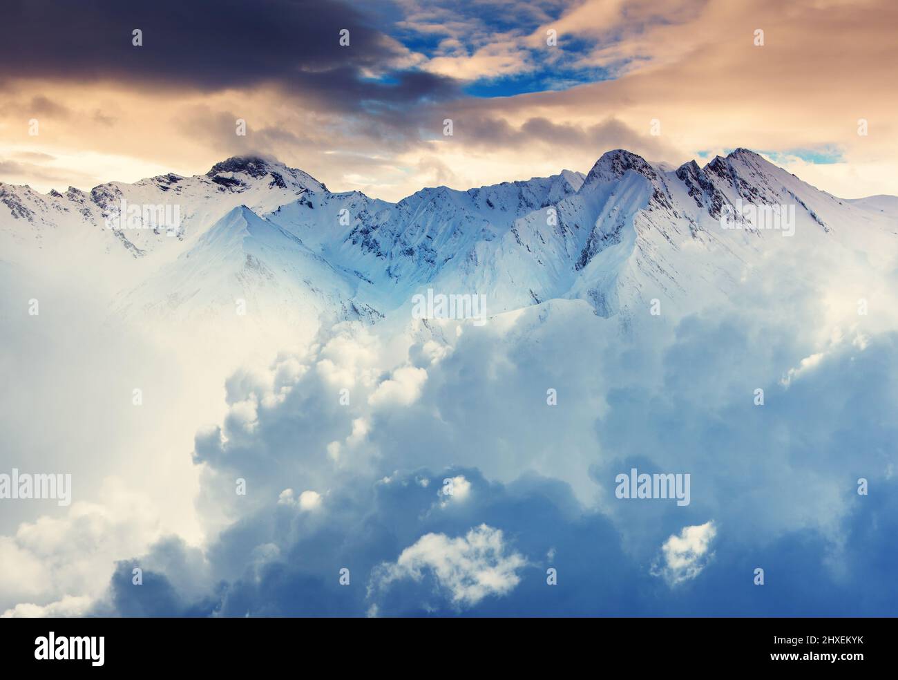Fluffy clouds covered the mountain range. Dramatic and picturesque ...