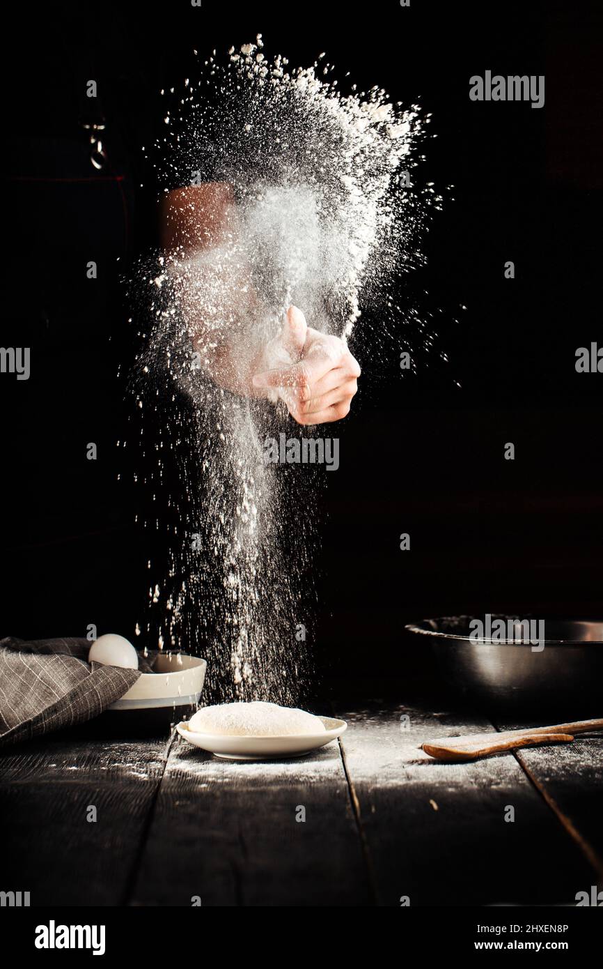Baker hand with flour pizza preparation Stock Photo - Alamy