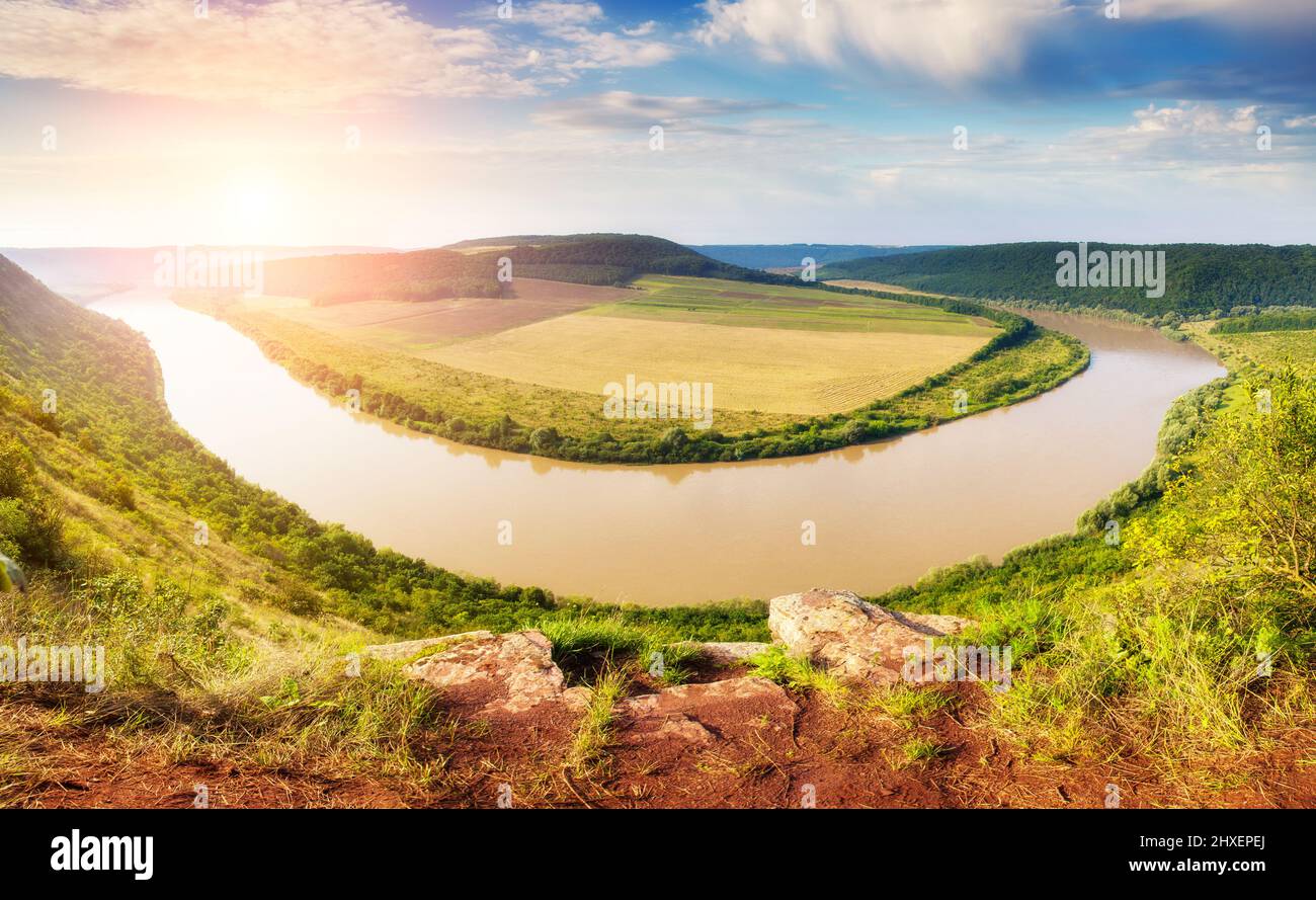 Sinuous river flowing through the canyon in the sunlight. Dramatic and ...