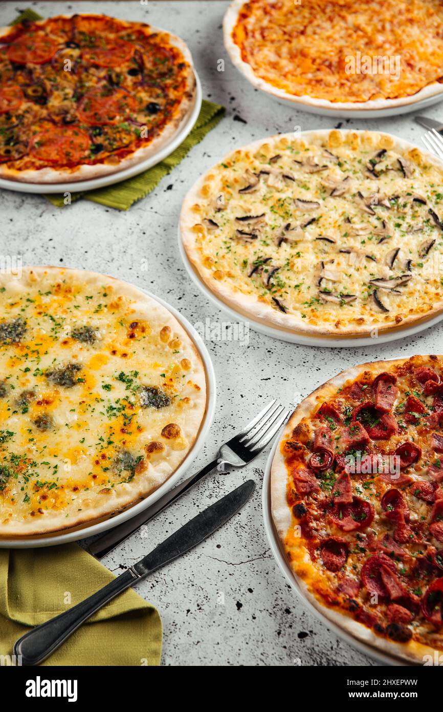 Group of different freshly baked pizzas Stock Photo - Alamy