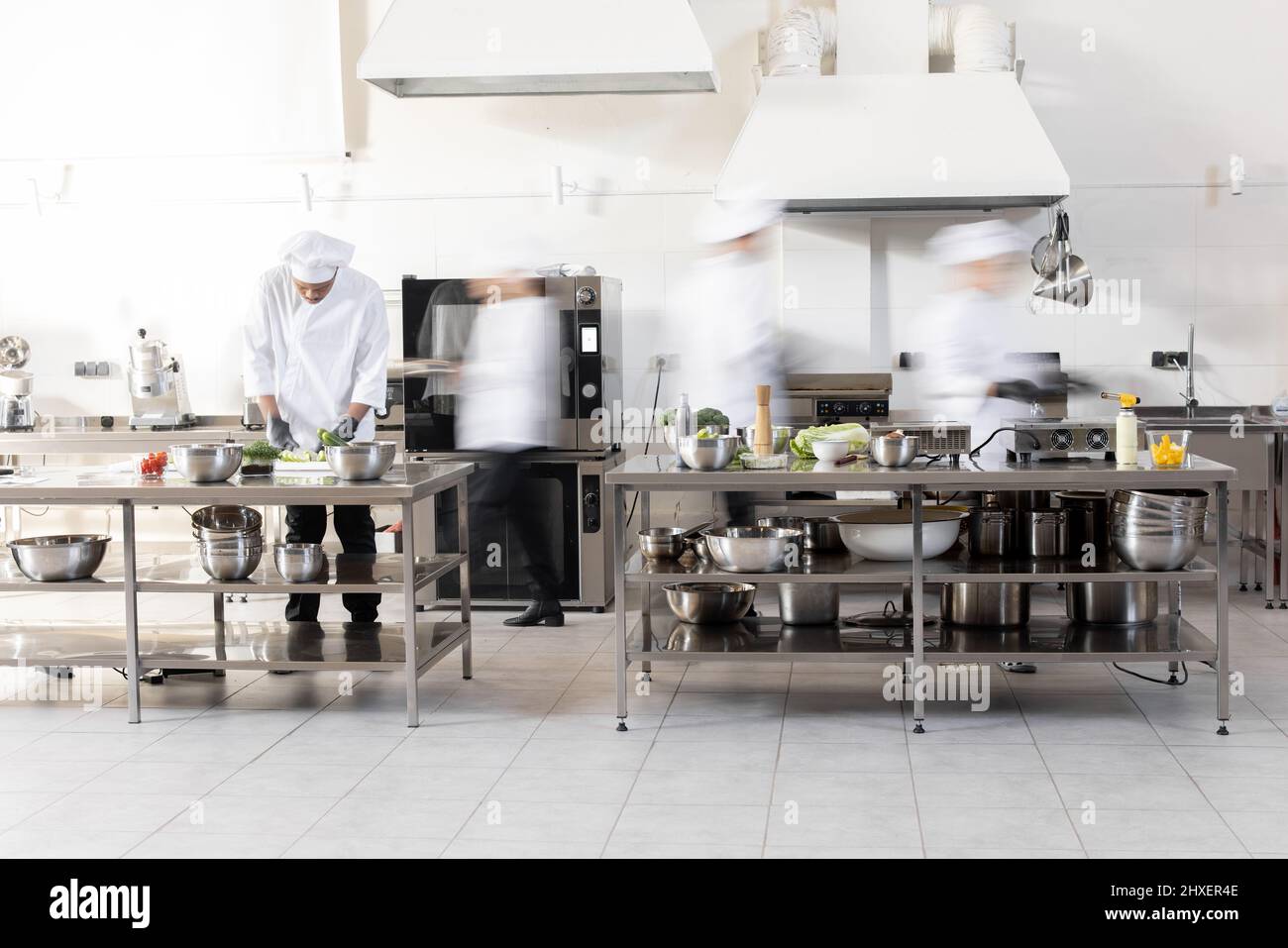 Chef cooks working in professional kitchen. Chefs hurry up, actively ...