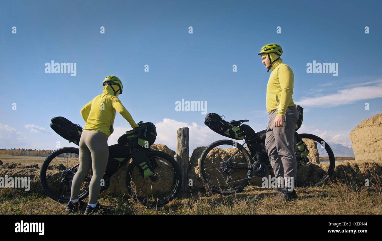The man and woman travel on mixed terrain cycle touring with ...