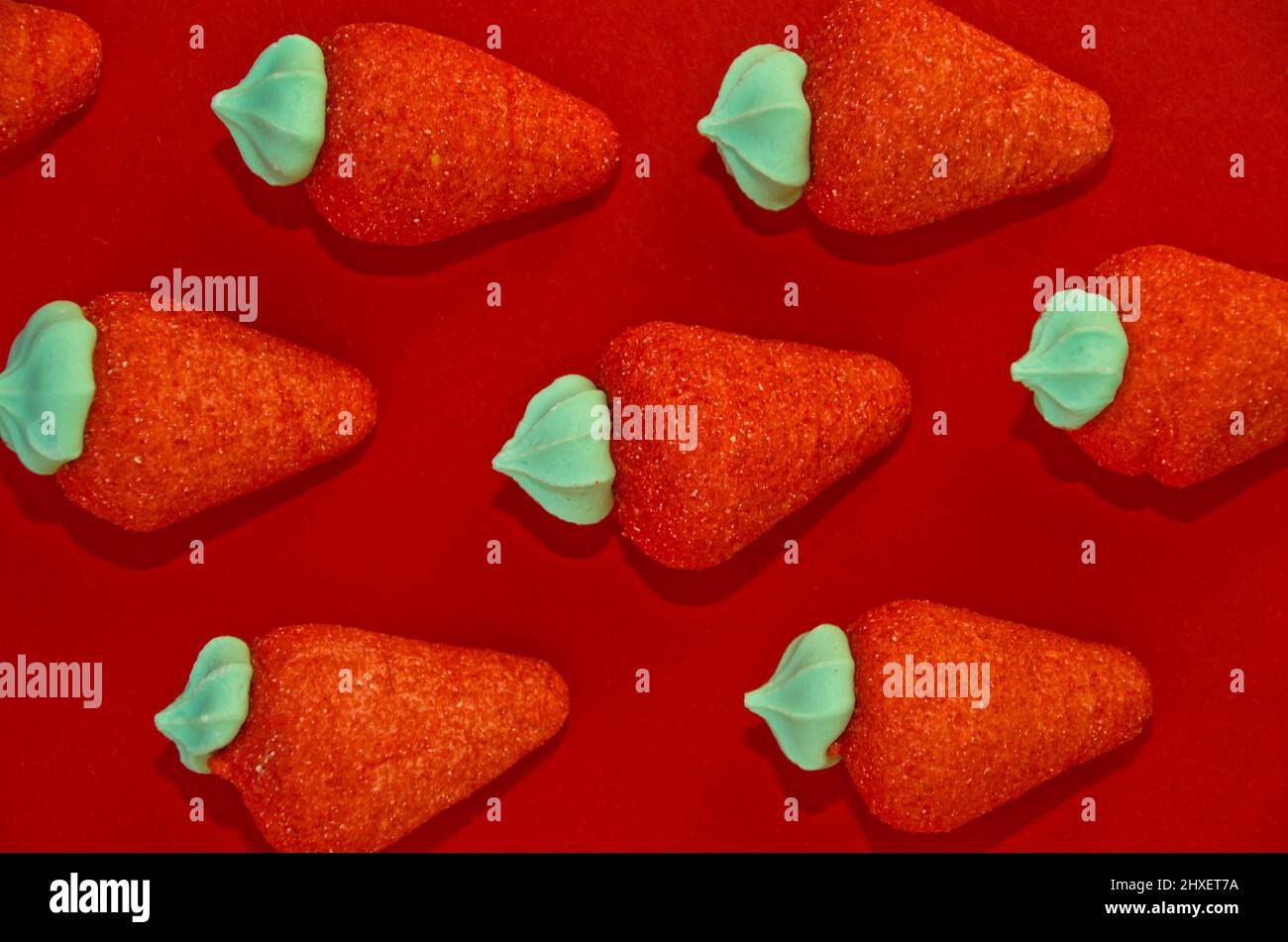 red marshmallow strawberries on a red background Stock Photo - Alamy