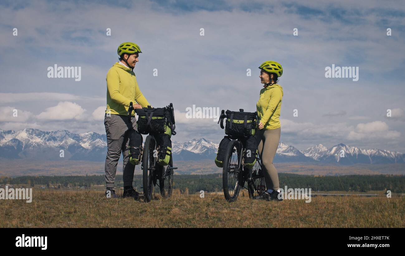 The man and woman travel on mixed terrain cycle touring with ...