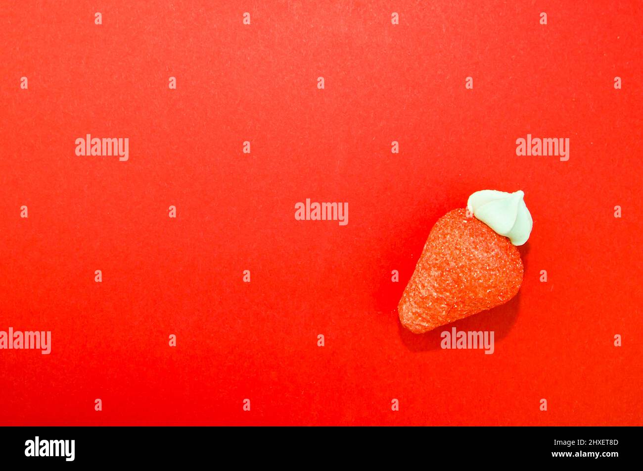 red marshmallow strawberries on a red background Stock Photo - Alamy
