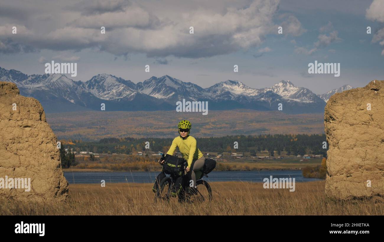 The woman travel on mixed terrain cycle touring with bikepacking. The ...