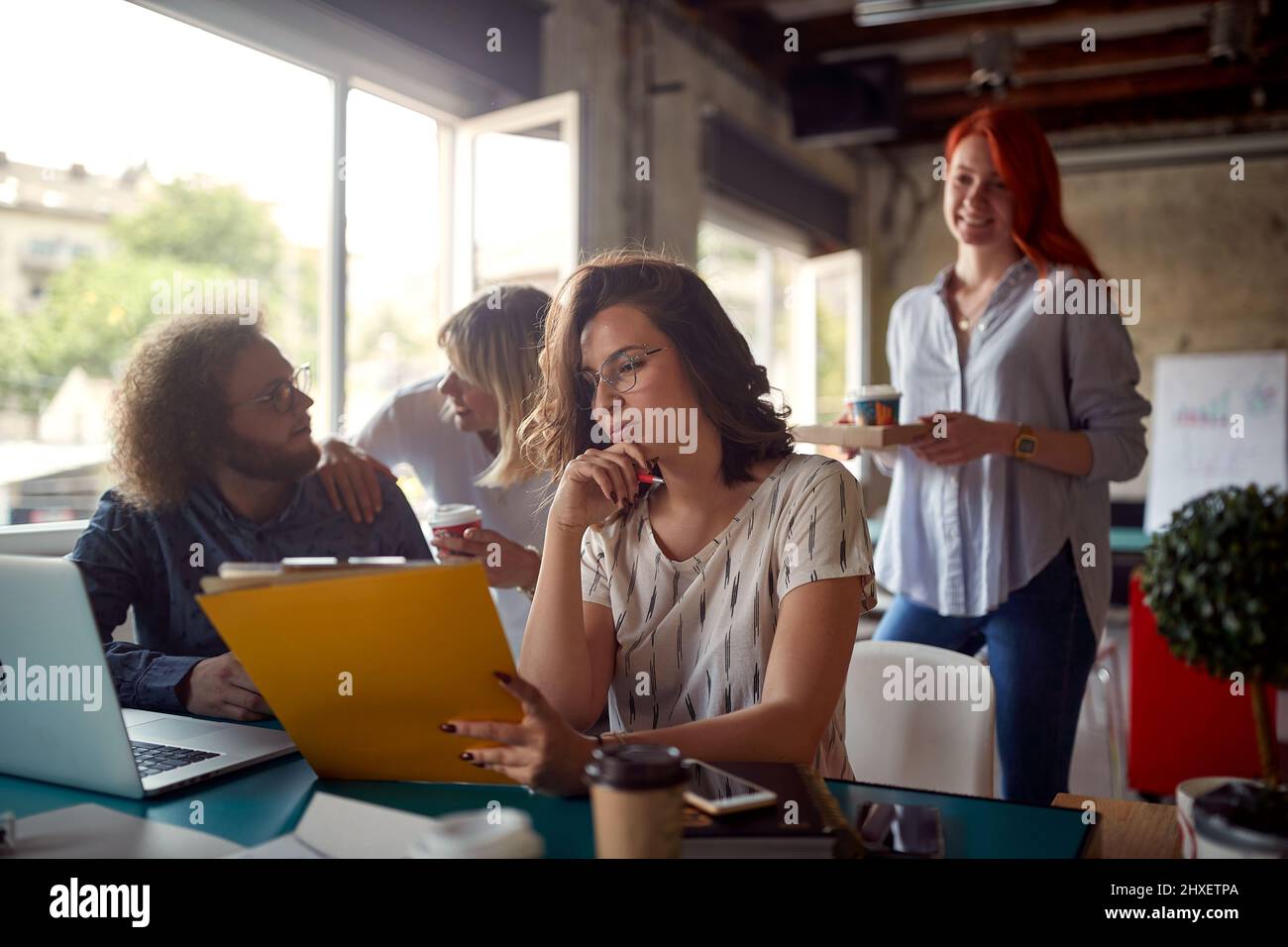 Group of young colleagues are working in a pleasant atmosphere in the ...