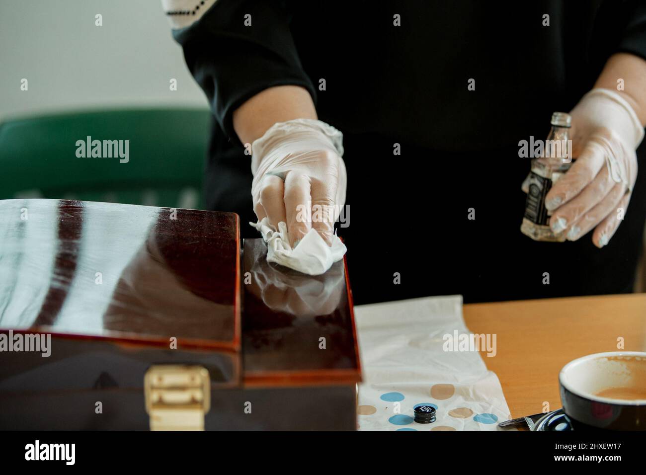 Women's hands in gloves prepare the wooden surface for painting ...