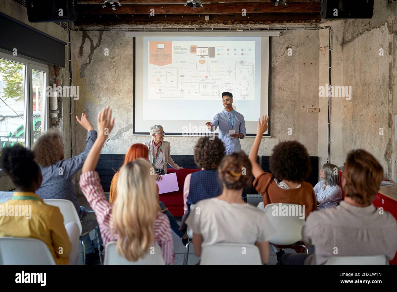 A young creative man is answering questions while holding a ...