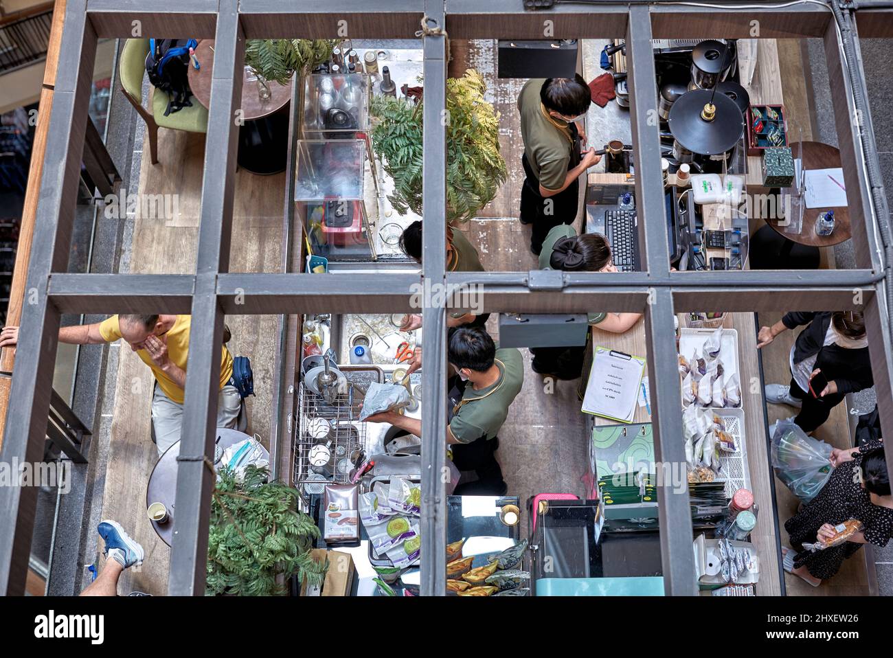 People from above. Coffee shop interior with Barista working behind the ...