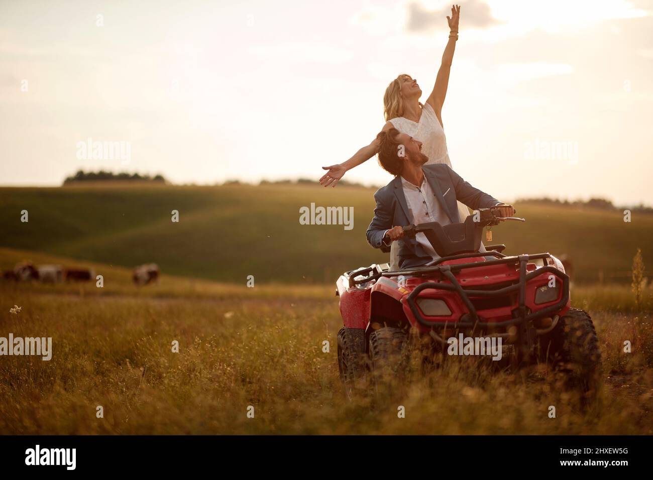 Happy man and woman in love on the mountainon on atv vehicle. Wedding ...